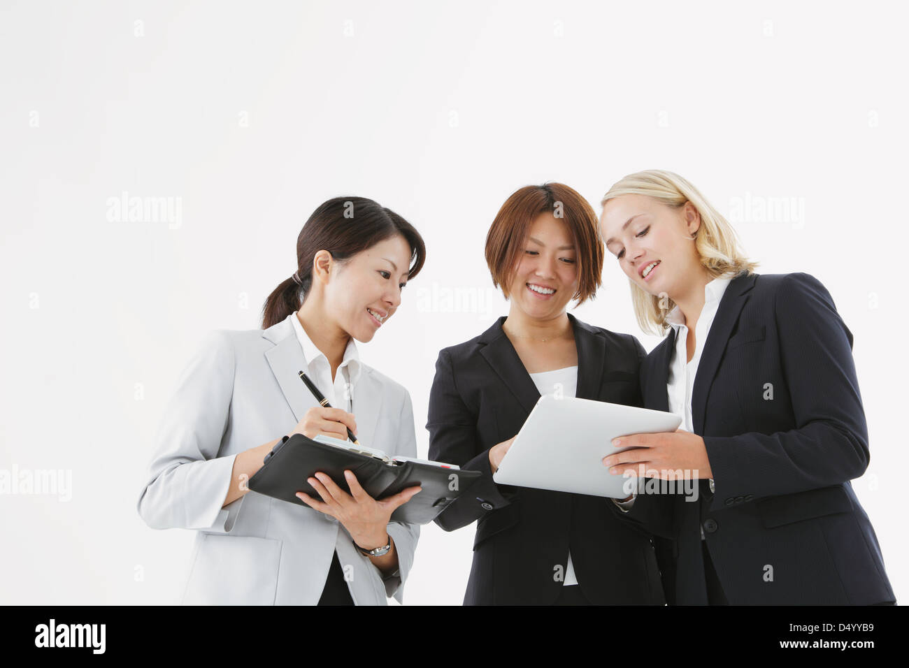 Businesswomen checking tablet Stock Photo - Alamy