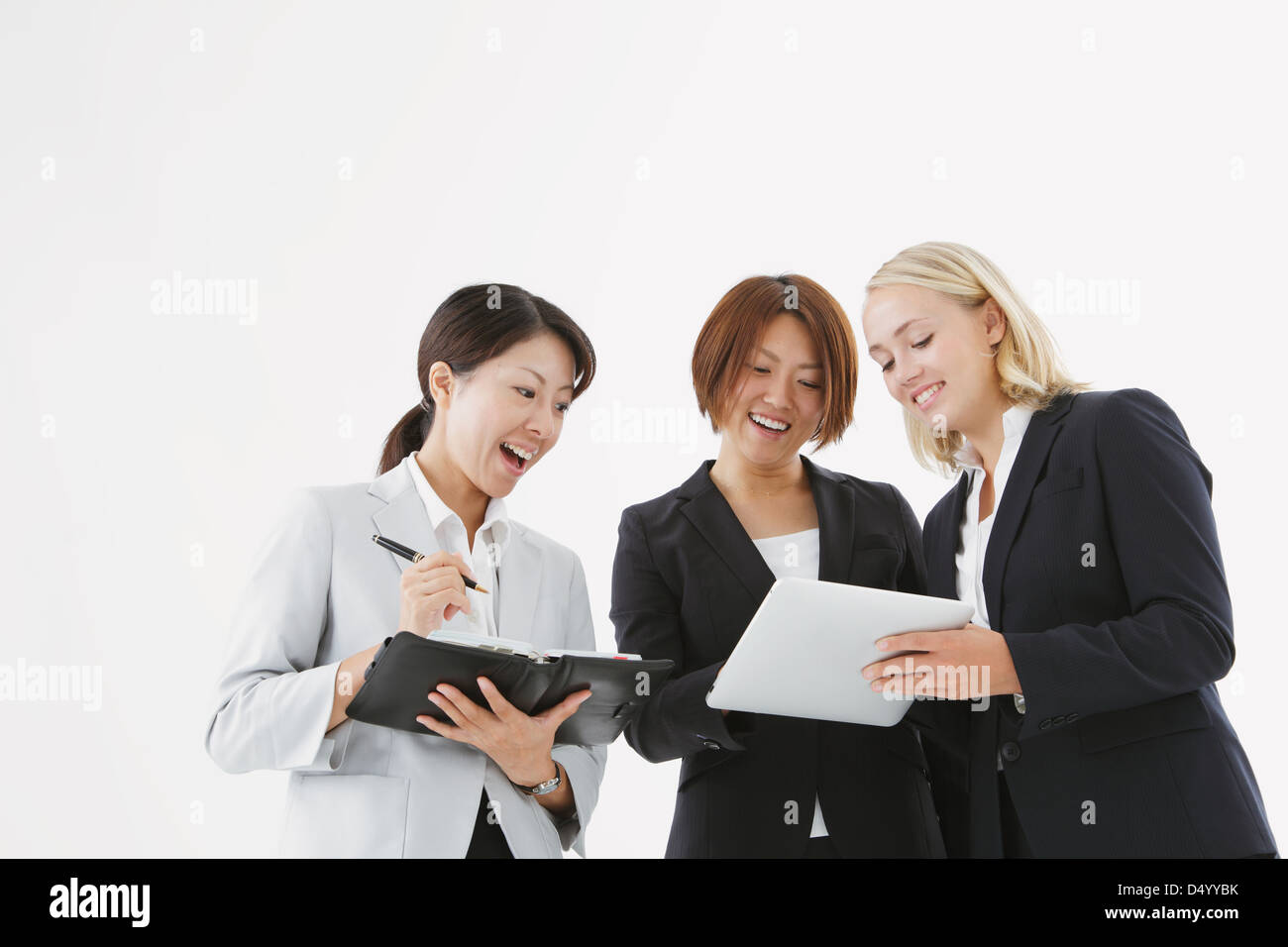Businesswomen checking tablet Stock Photo - Alamy