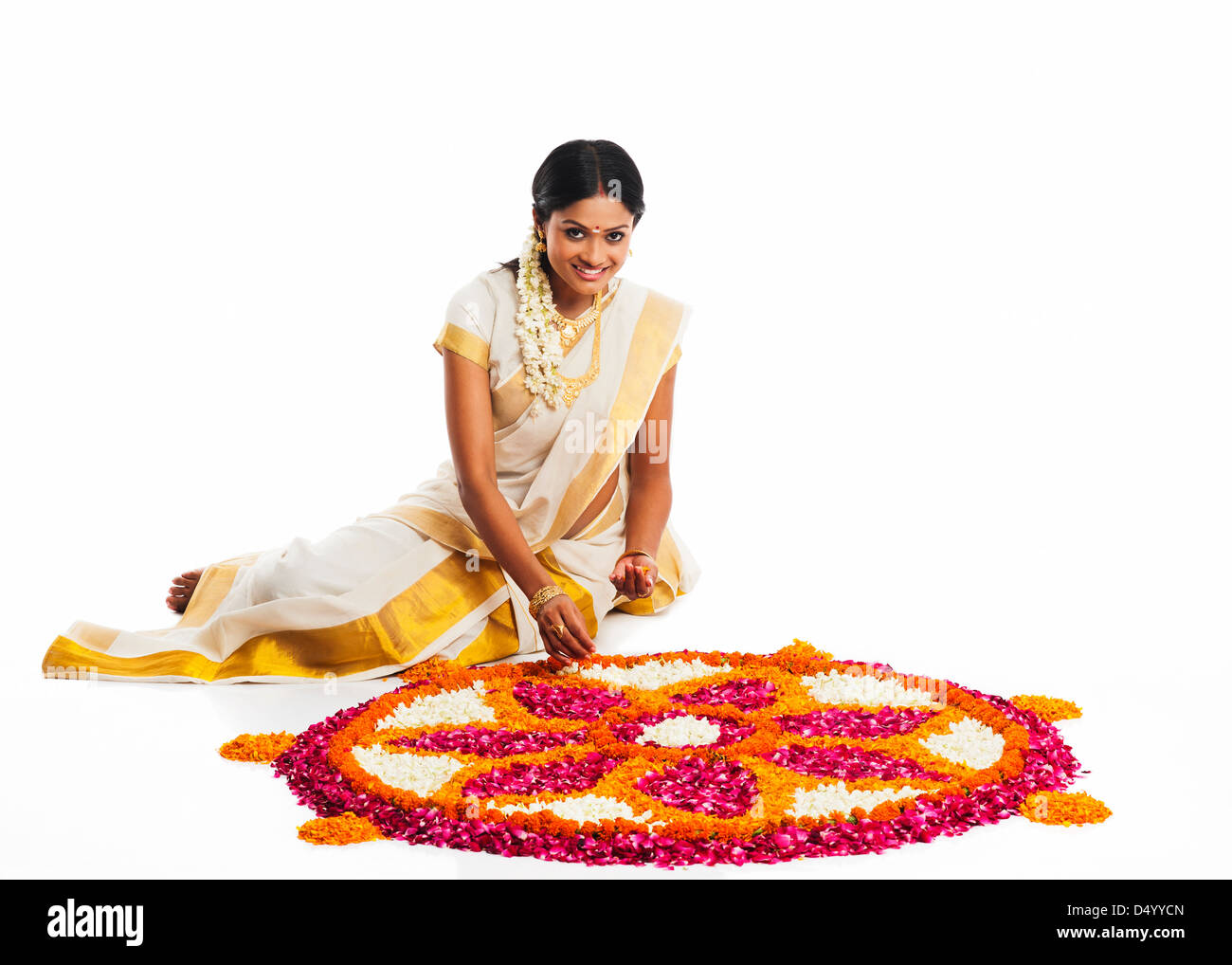 South Indian woman making a rangoli of flowers at Onam Stock Photo - Alamy