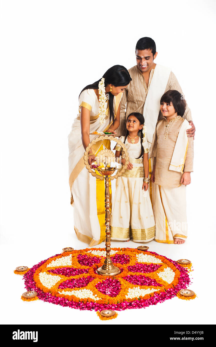South Indian family lighting oil lamp at Onam Stock Photo - Alamy