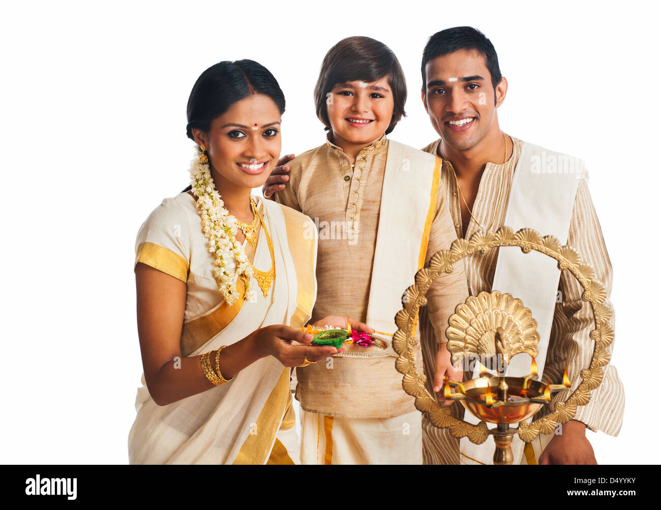 South Indian family lighting oil lamp at Onam Stock Photo - Alamy