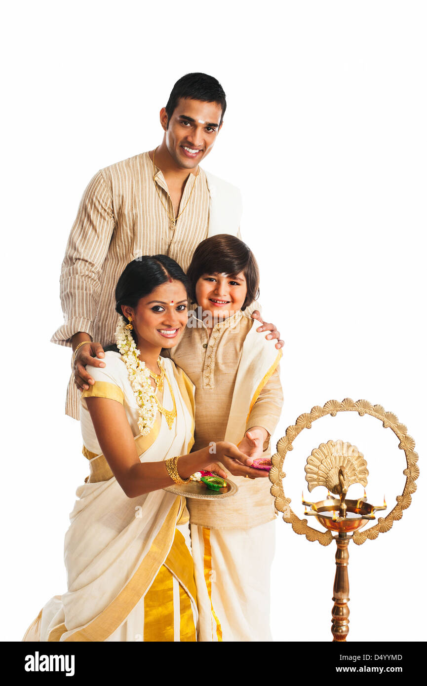 South Indian family lighting oil lamp at Onam Stock Photo - Alamy
