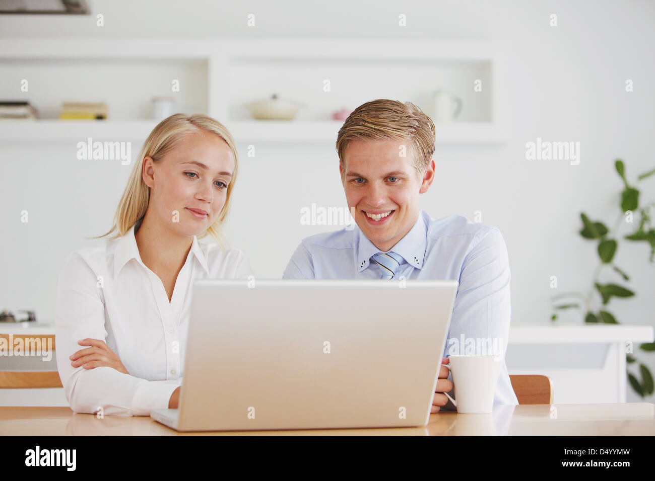 Couple looking at laptop Stock Photo - Alamy
