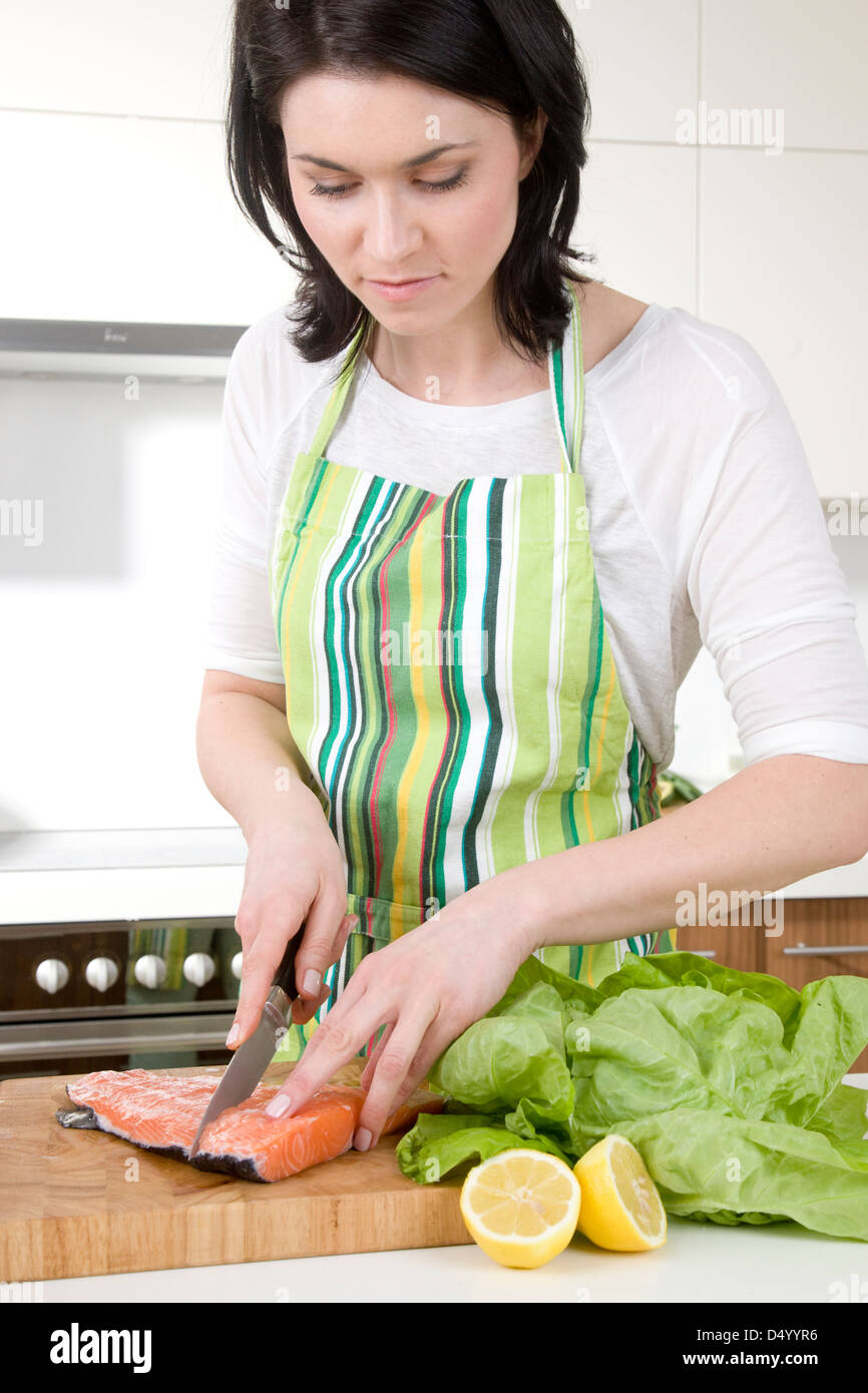 Woman cutting fish hi-res stock photography and images - Alamy