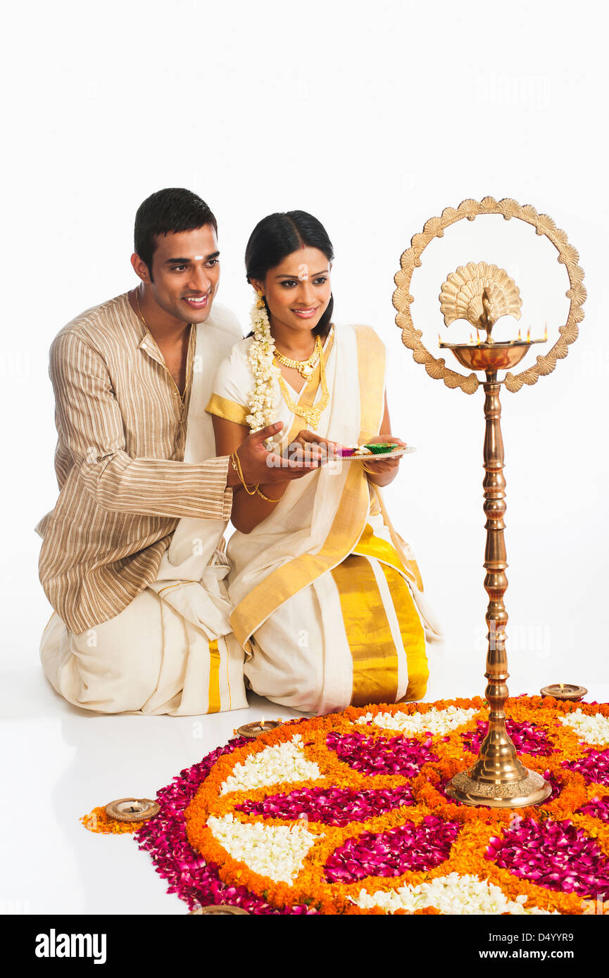 South Indian couple lighting oil lamp at Onam Stock Photo - Alamy
