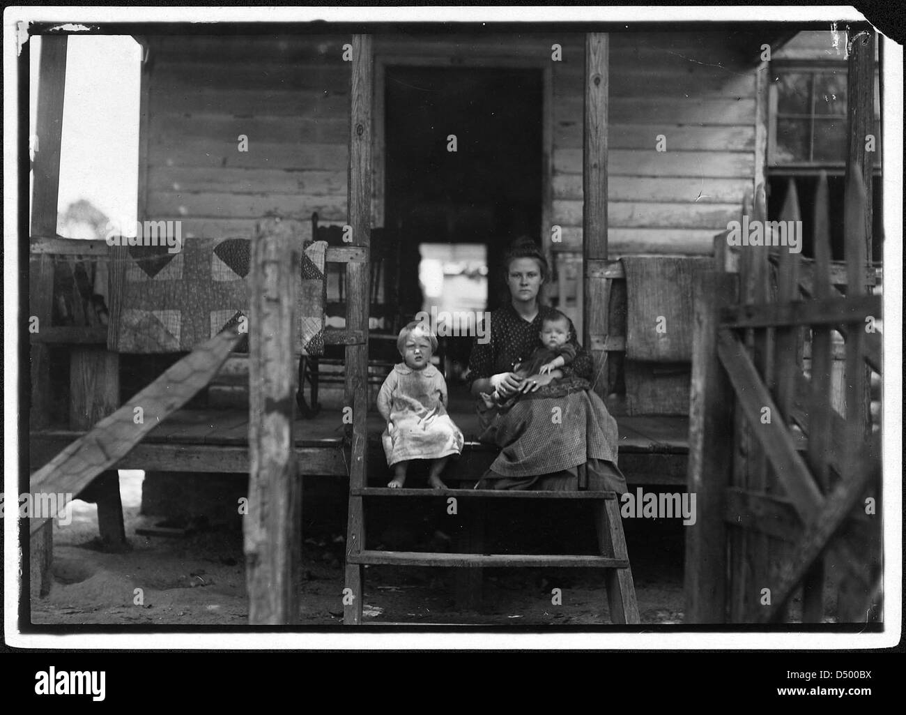 Mrs. L. Bosher is photographed in a run-down cotton mill village in ...