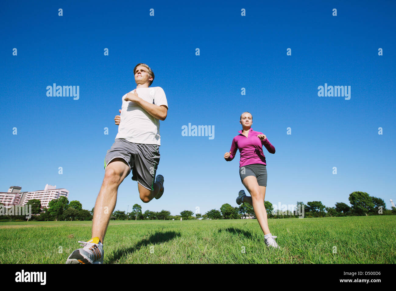 Couple running in a park Stock Photo - Alamy