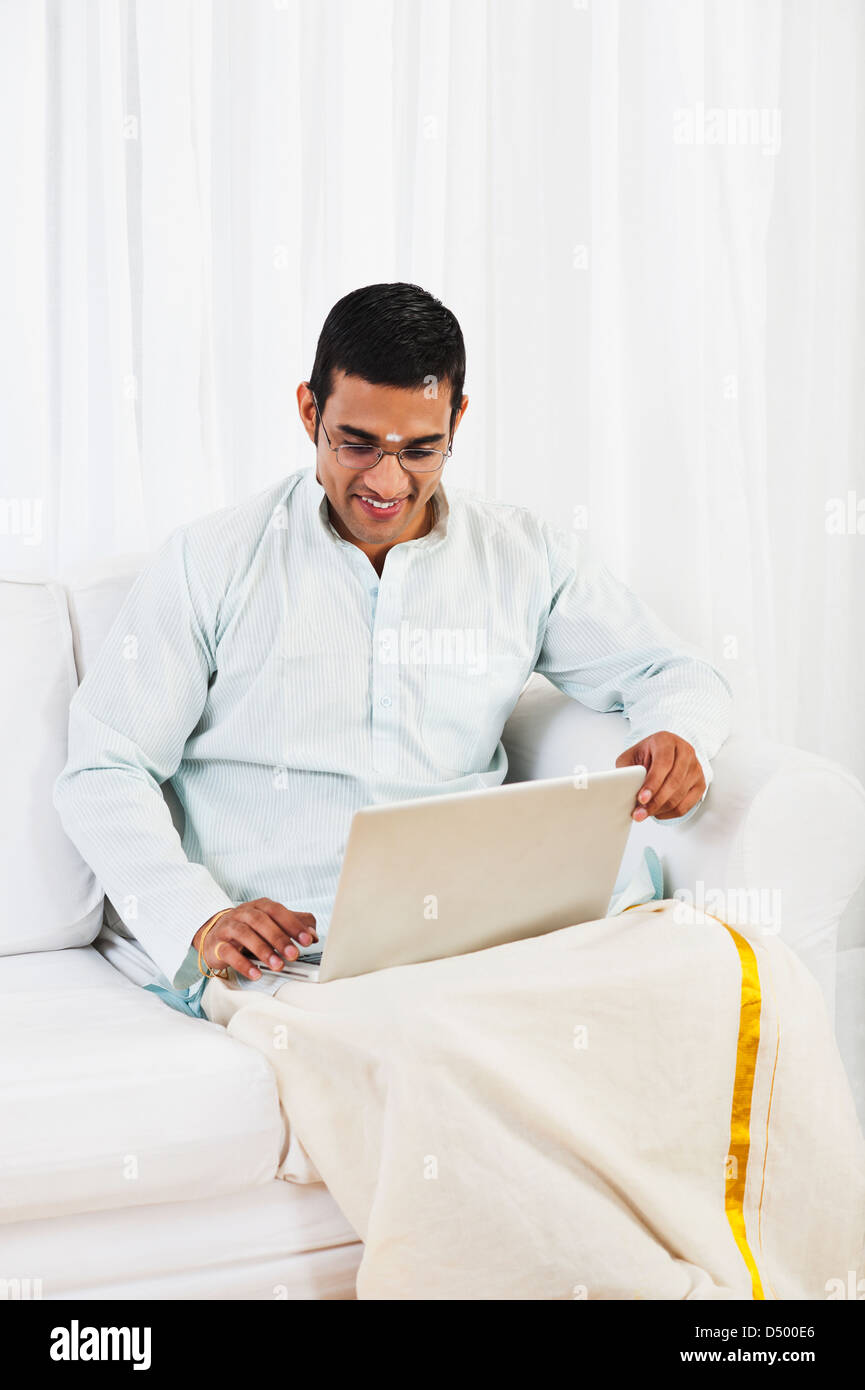 South Indian man using a laptop Stock Photo - Alamy