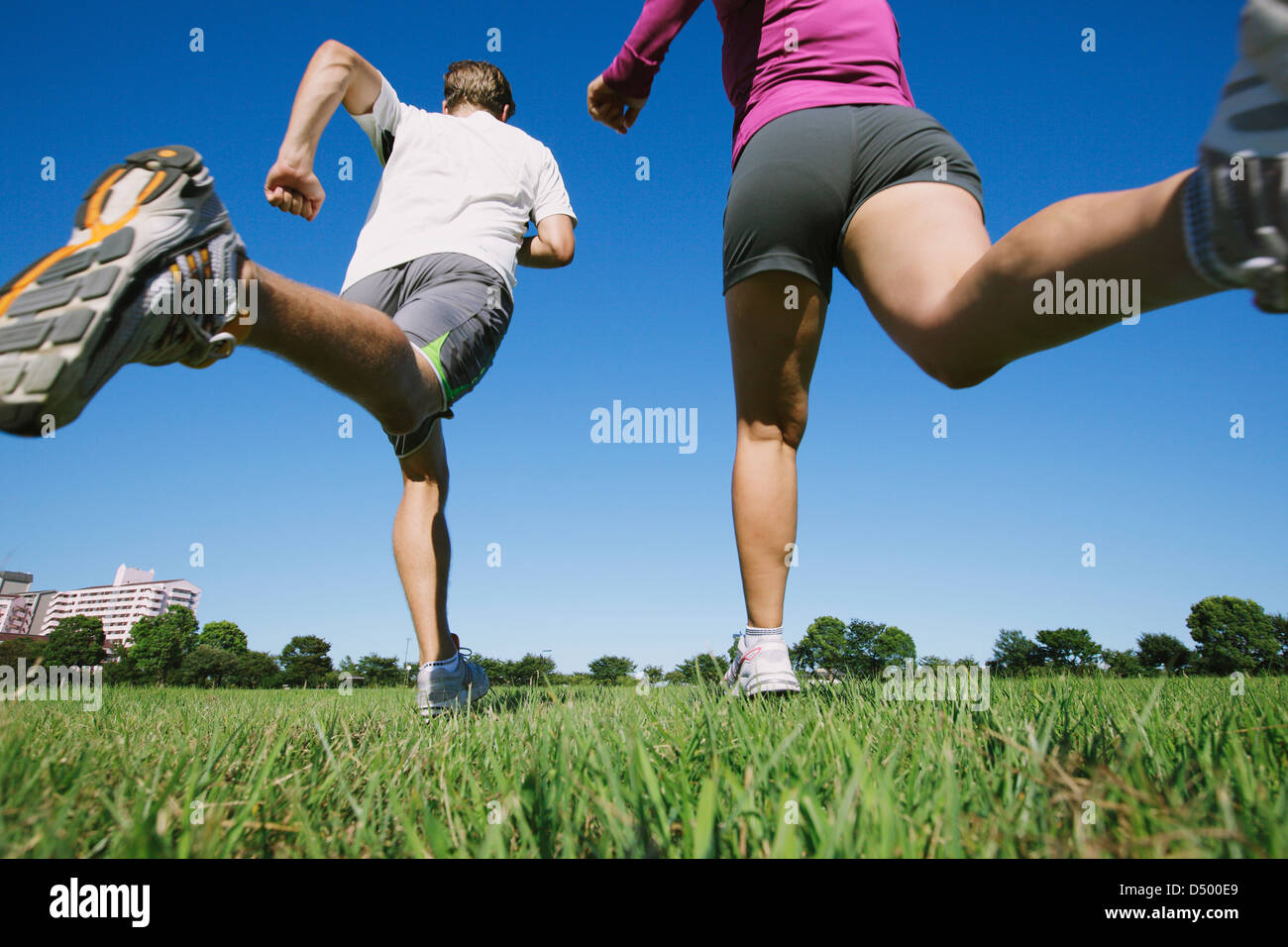 Couple running in a park Stock Photo - Alamy