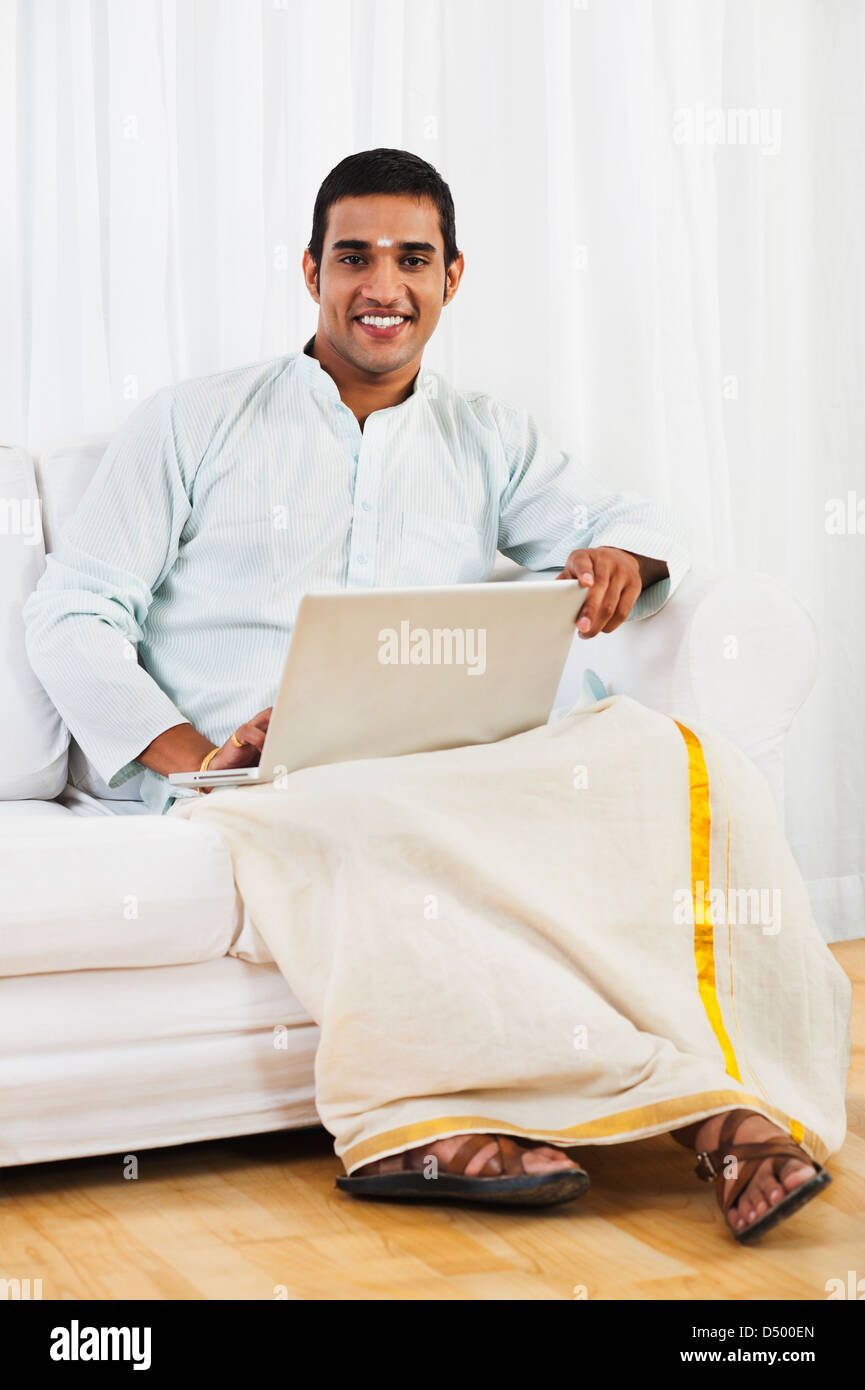 South Indian man using a laptop Stock Photo - Alamy