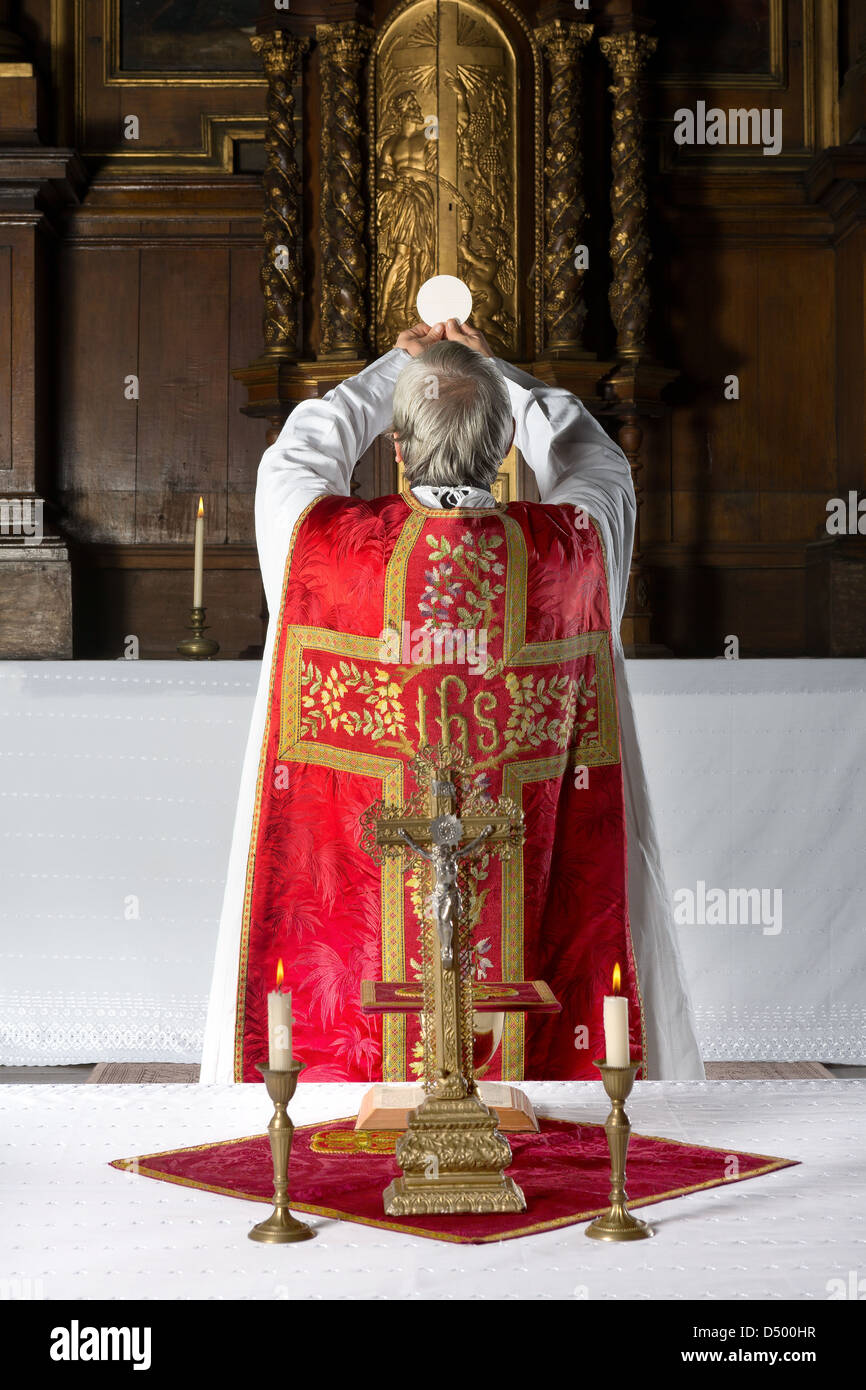 Catholic priest during consecration in hi-res stock photography and ...