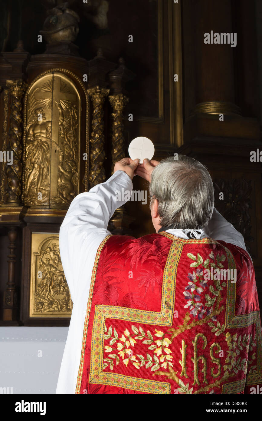 Catholic priest during consecration in hi-res stock photography and ...