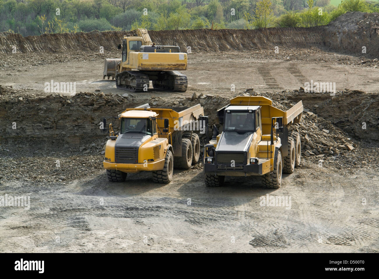 yellow stone pit digger and dump trucks in quarry ambiance Stock Photo ...