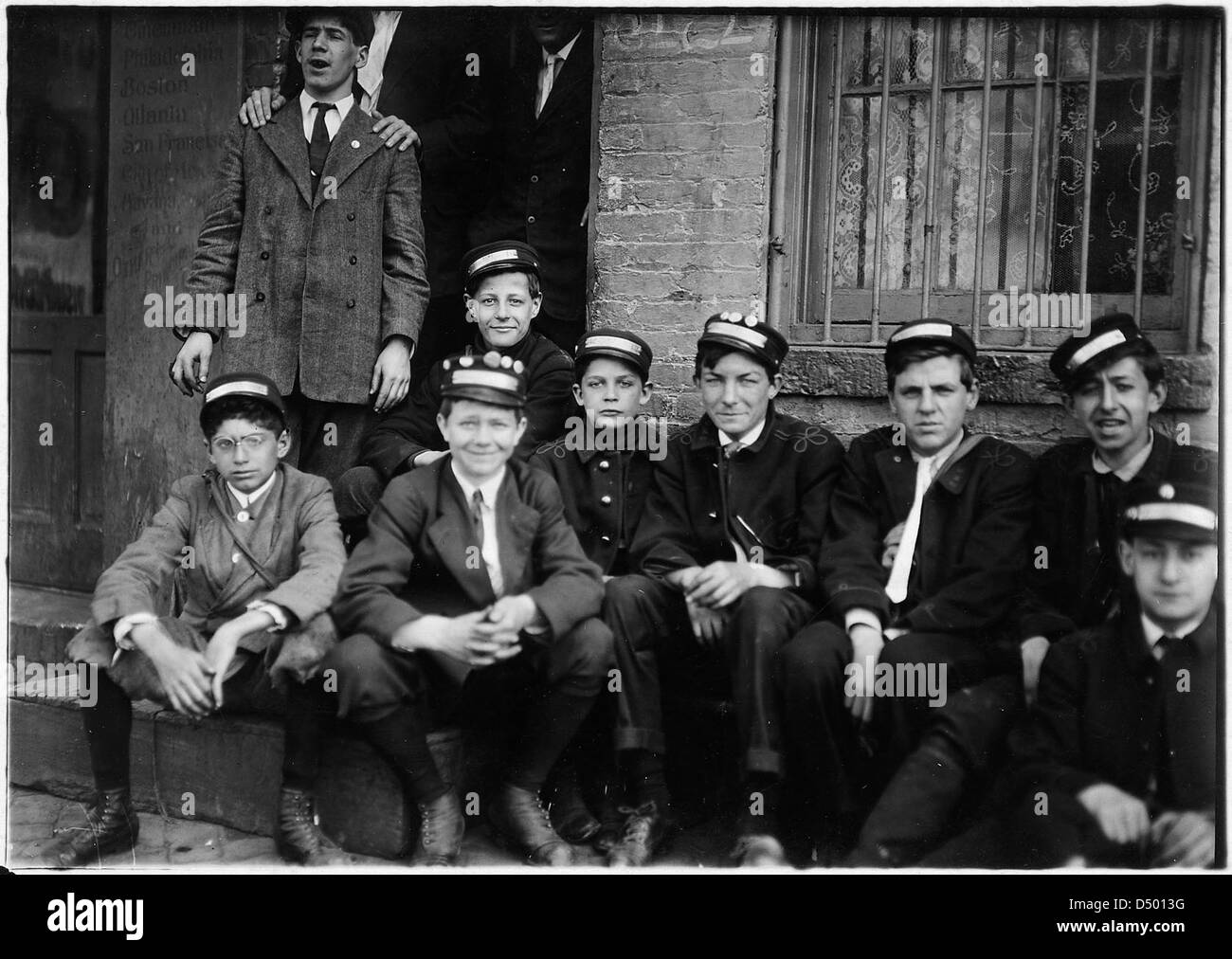This photograph from April 1912 by Lewis Hine shows a group of boys ...