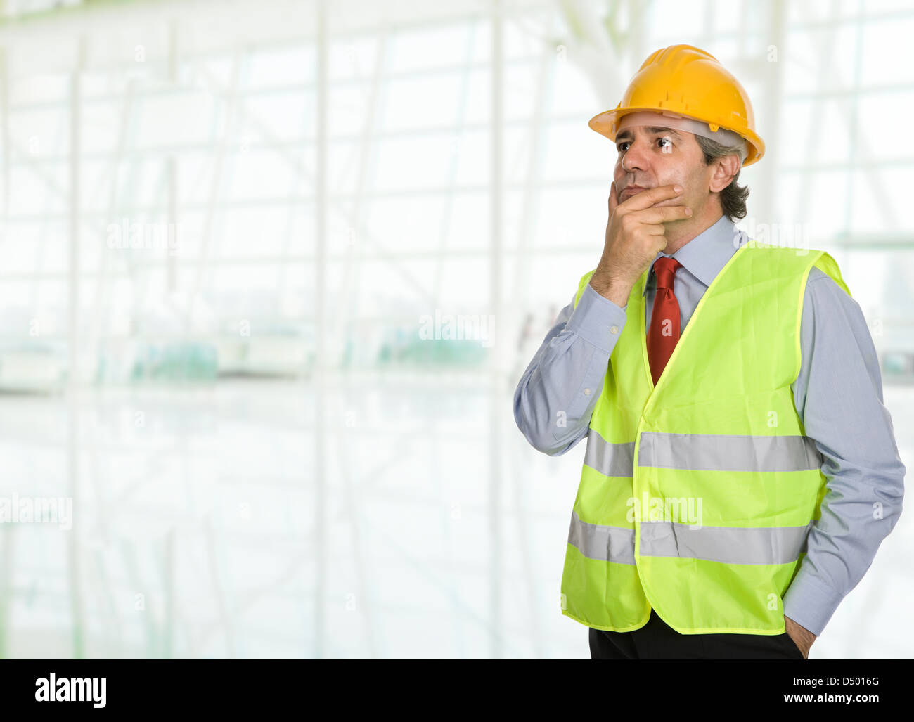 An engineer with yellow hat at the office Stock Photo - Alamy
