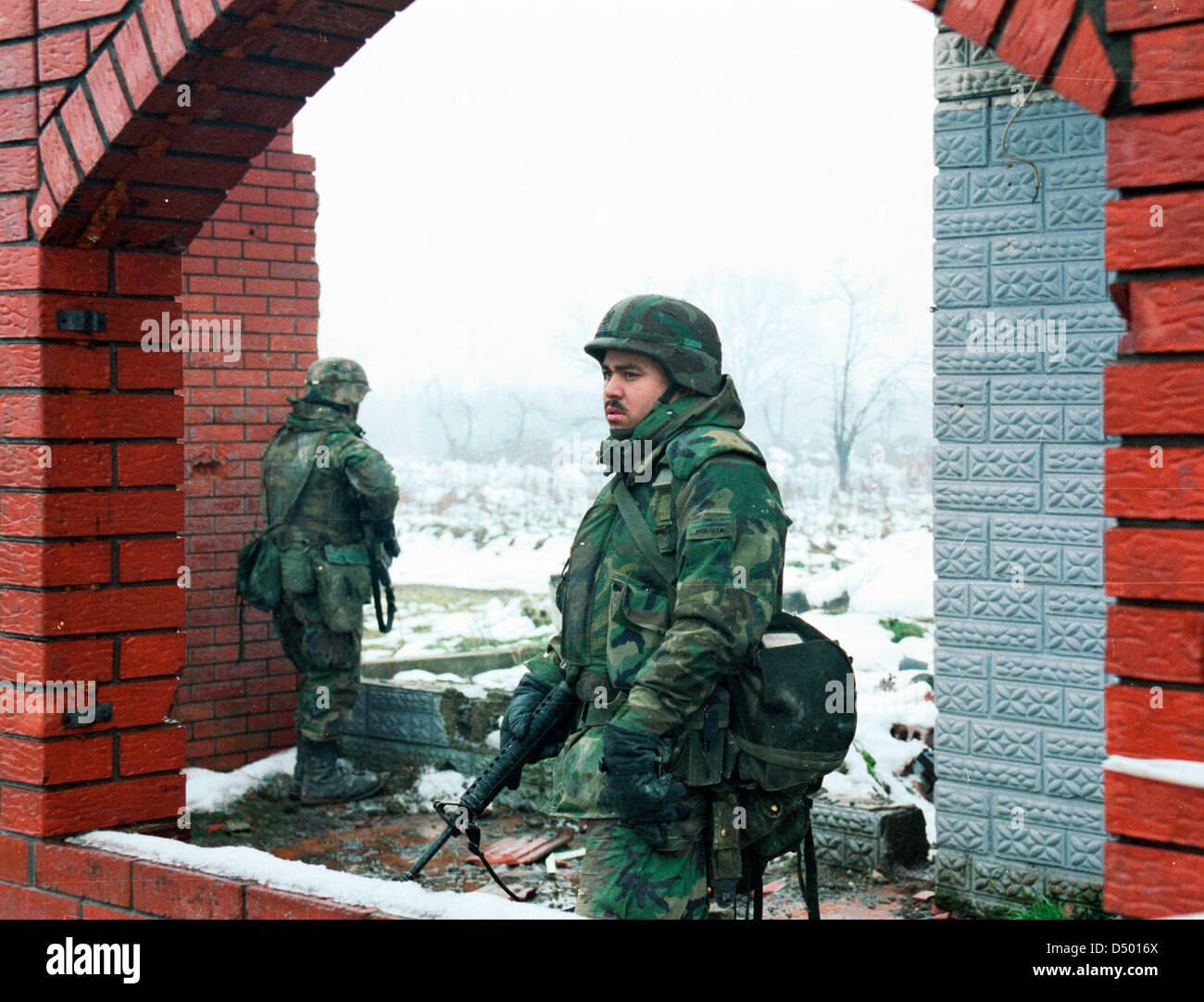 United States Army troops, in Bosnia as part of NATO's IFOR, protect a ...