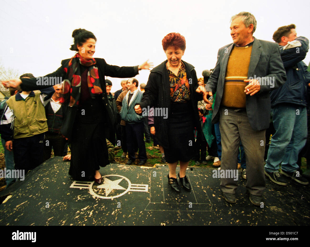 Serbian women dance atop the wing of an United States Air Force F-117A ...