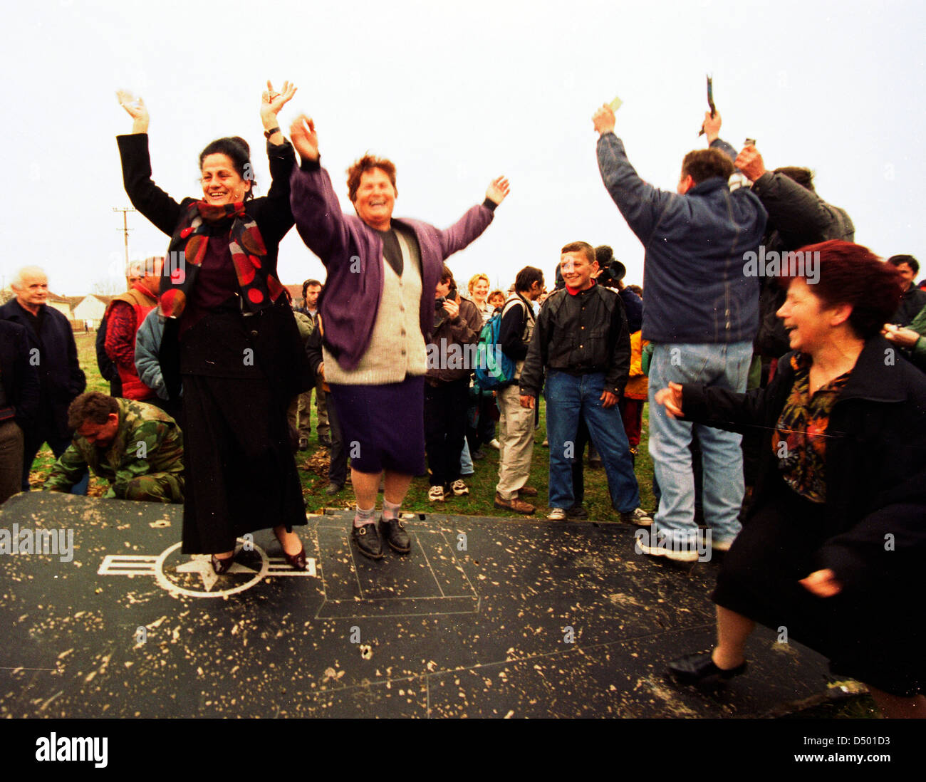 Serbian women dance atop the wing of an United States Air Force F-117A ...
