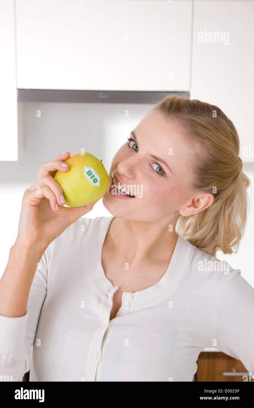 Woman eating bio apple Stock Photo - Alamy