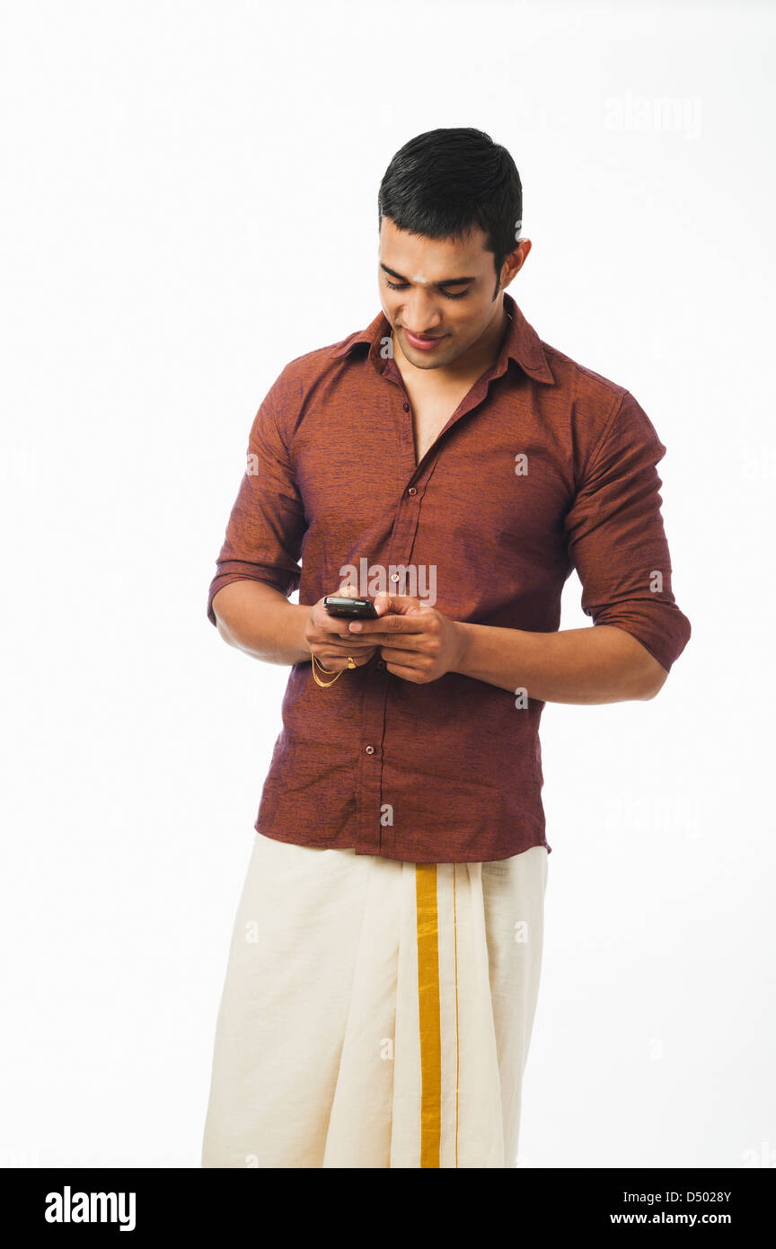 South Indian man text messaging on a mobile phone Stock Photo - Alamy
