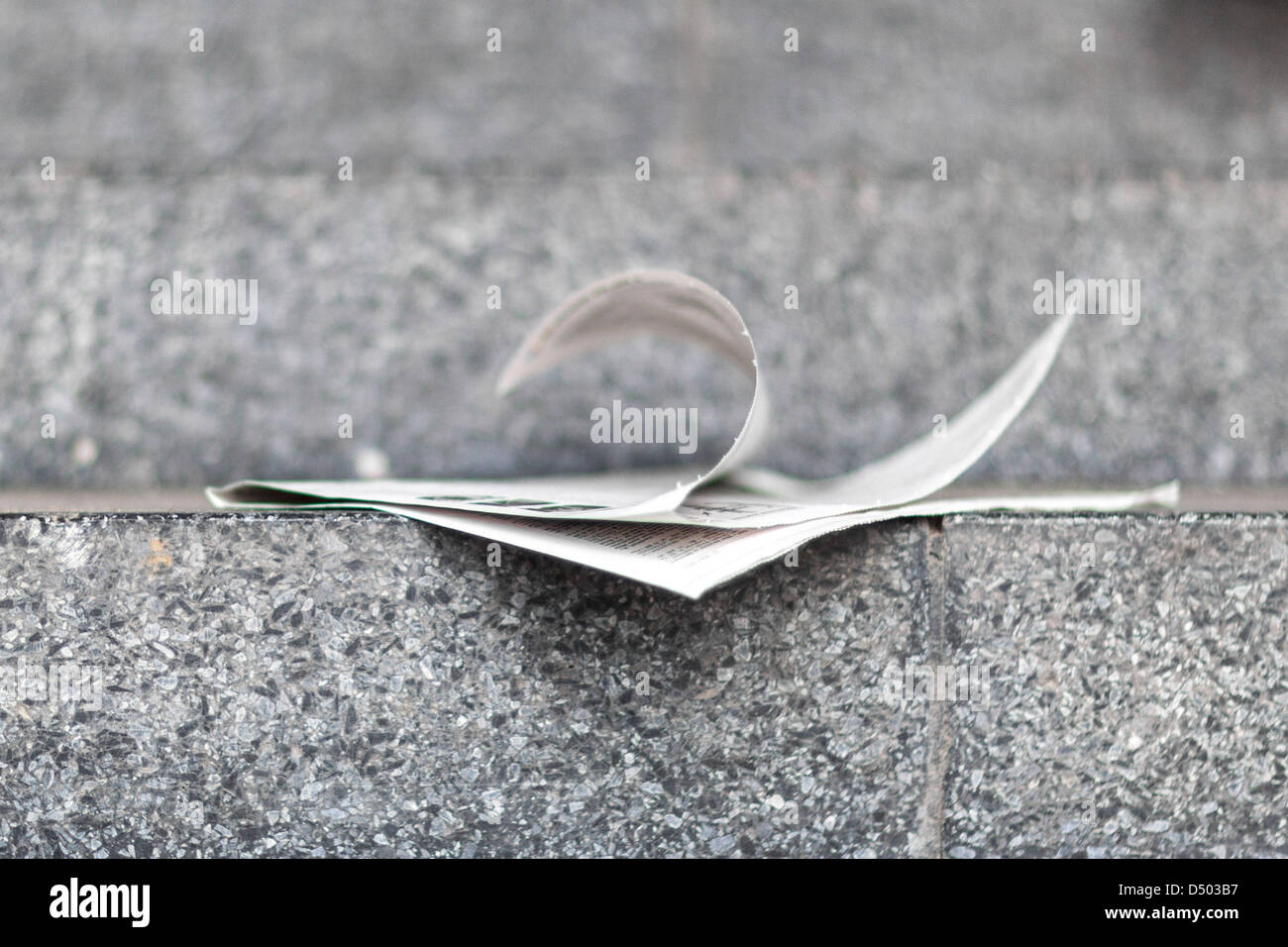 A newspaper is blown in the wind Stock Photo - Alamy