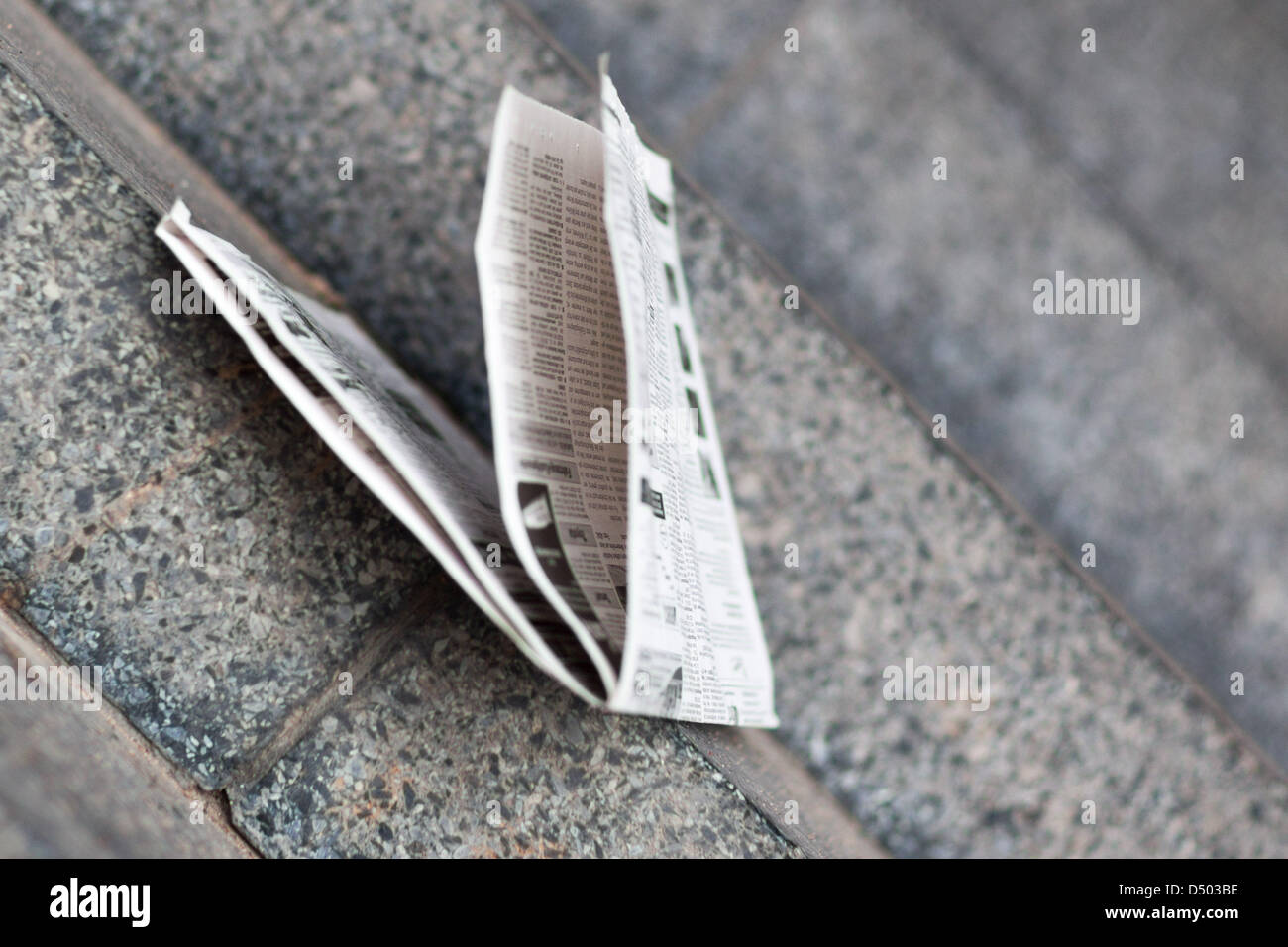 A newspaper is blown in the wind Stock Photo - Alamy