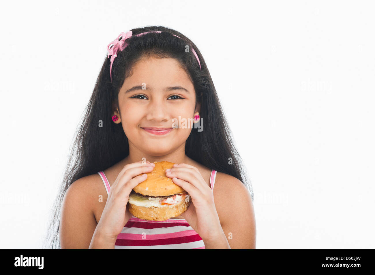 Girl eating a burger Stock Photo - Alamy