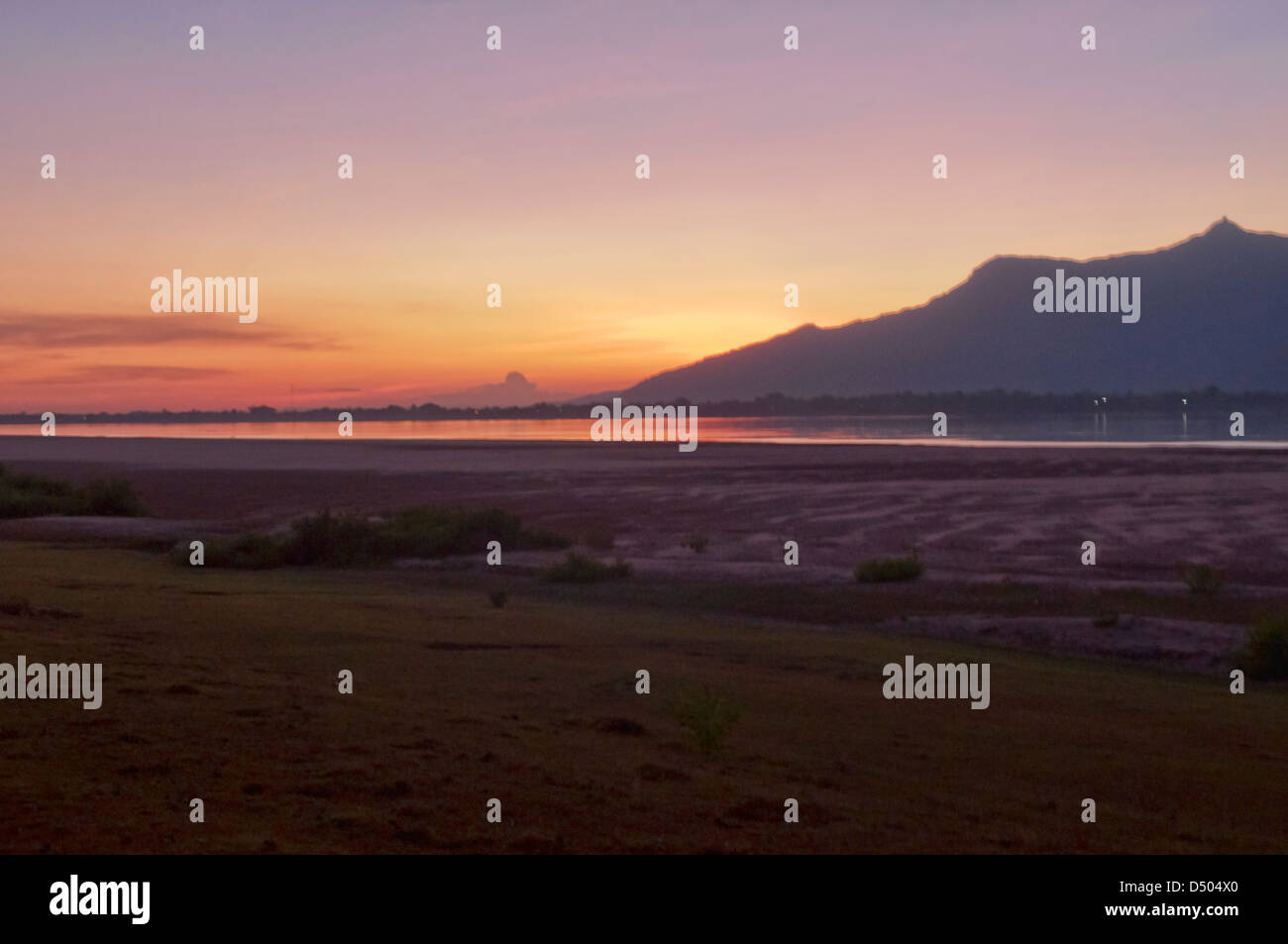 sunset over Wat Phu seen from Don Daeng Island along the Mekong River ...