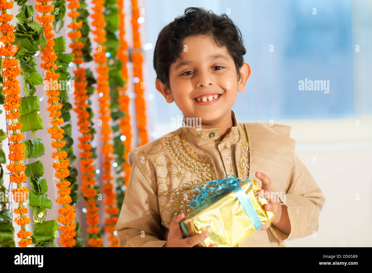 Boy holding a gift on Diwali Stock Photo - Alamy