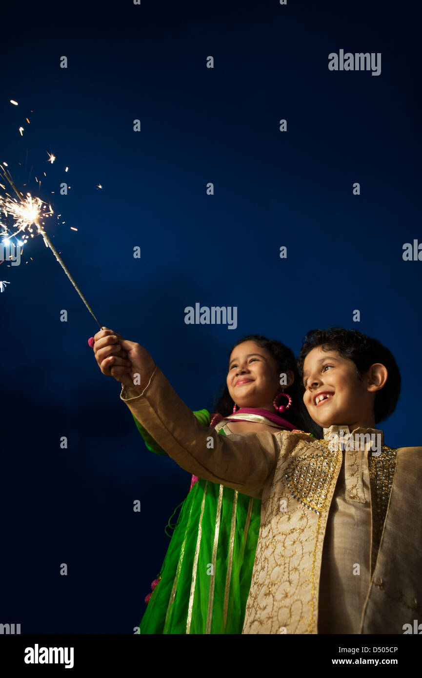 Children burning fire crackers on hi-res stock photography and images ...