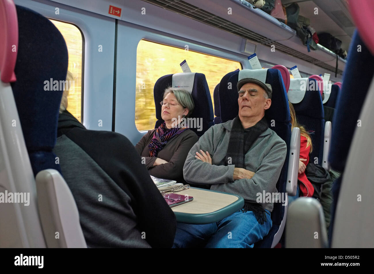 Two people asleep on a UK train Stock Photo - Alamy