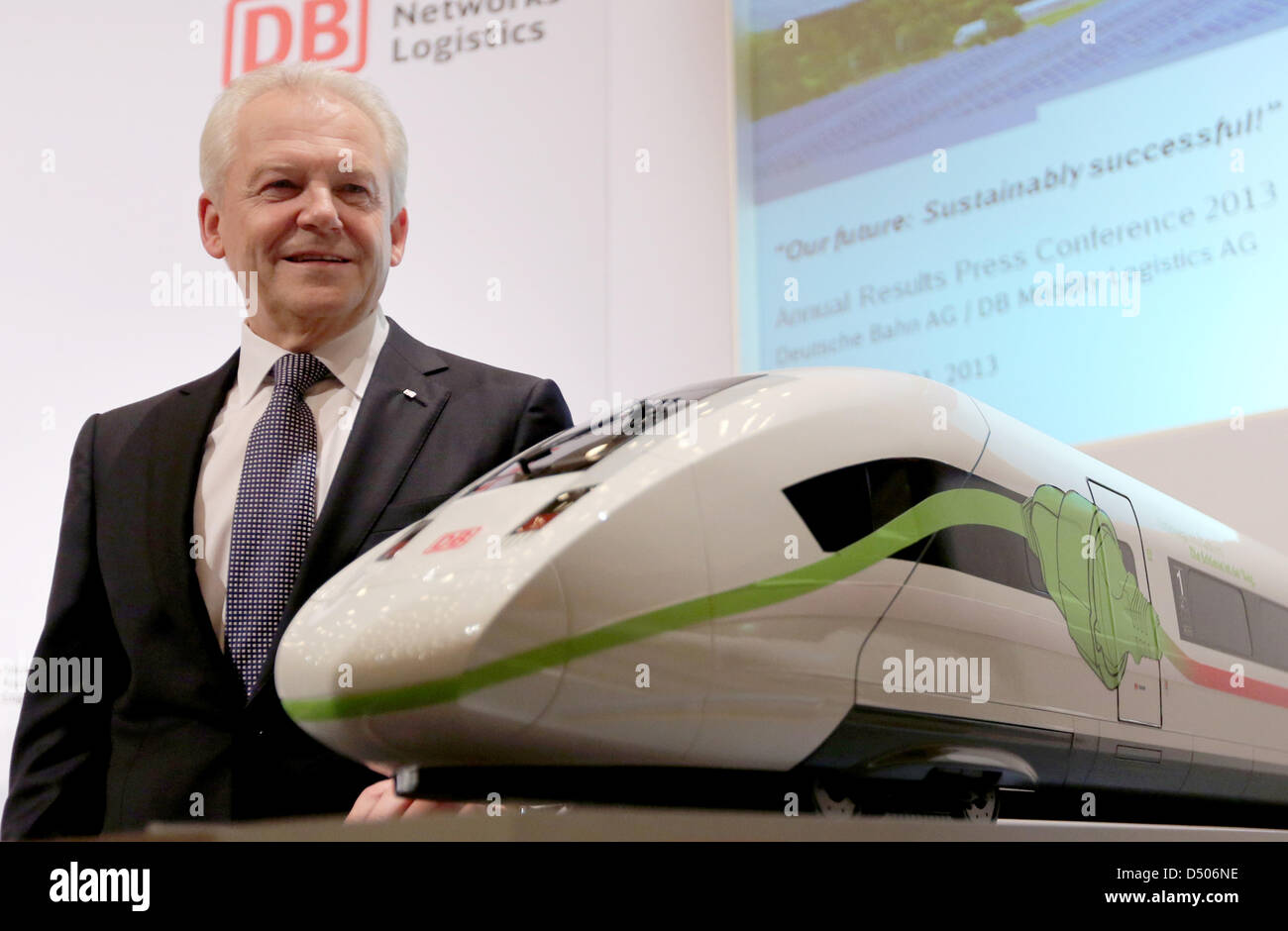 Deutsche Bahn CEO Ruediger Grube poses next to a model train during the ...
