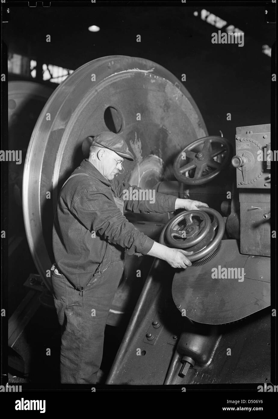 Railroad parts. Baldwin Locomotive Works. Machinist machining wheel to ...