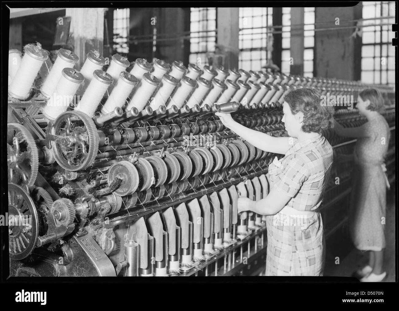 A photograph from March 1937 by Lewis Hine shows two women working with ...