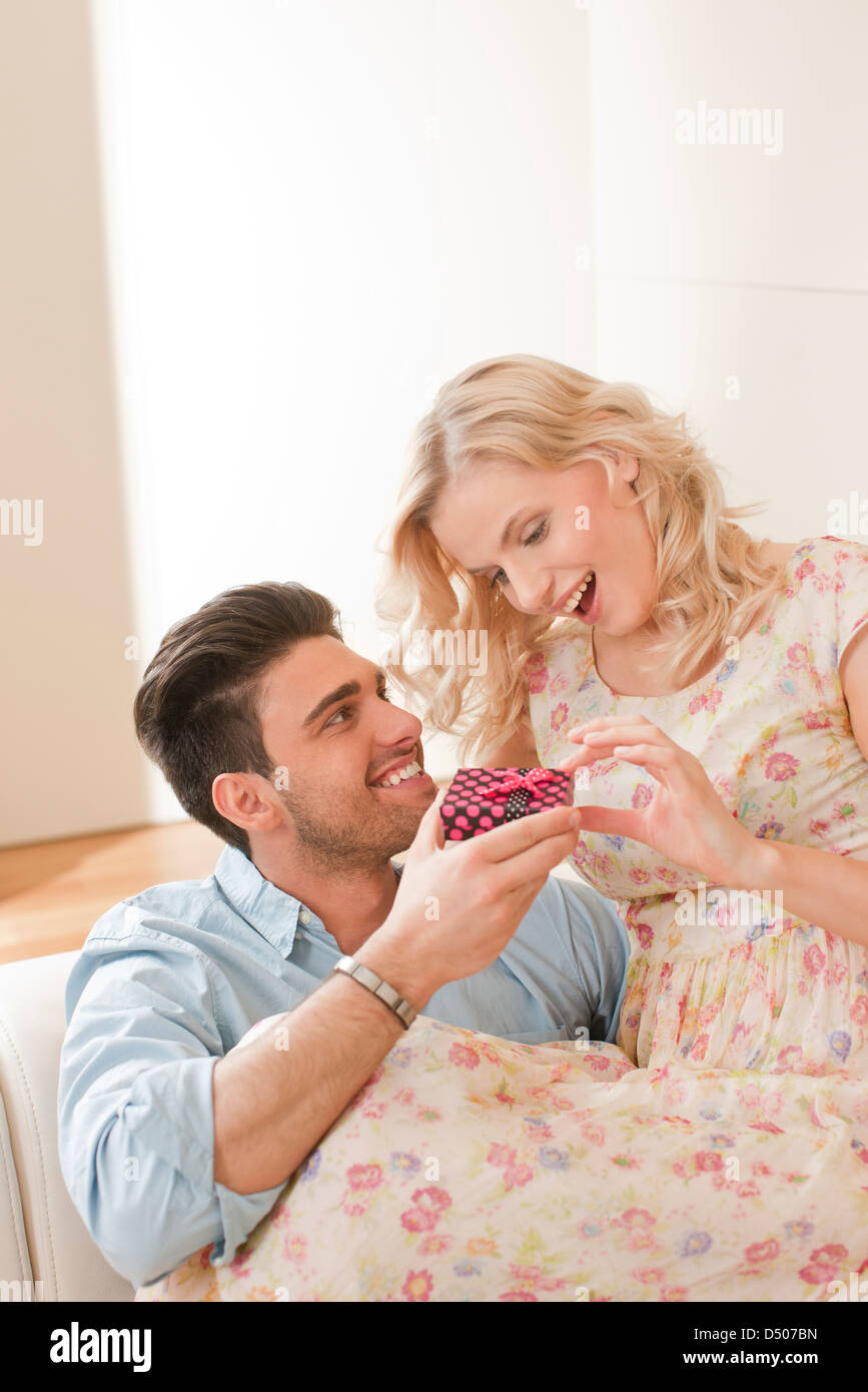 Man giving a gift to woman Stock Photo - Alamy