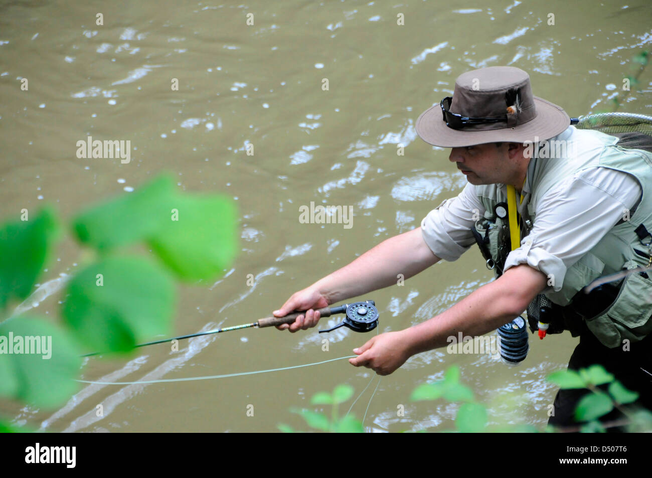 A man fly fishing in a river Stock Photo - Alamy