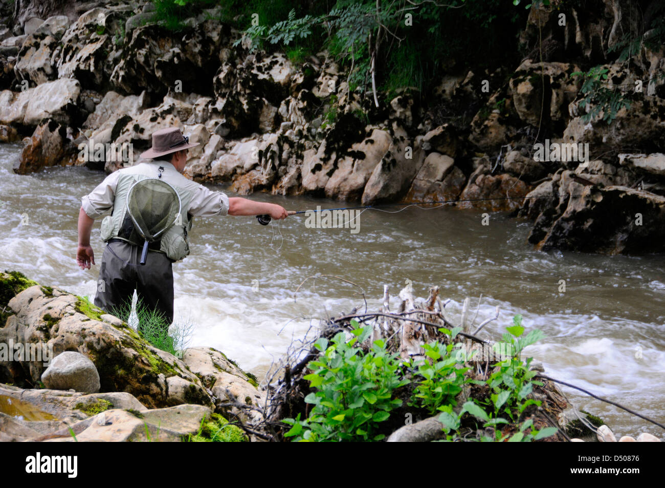 A man fly fishing in a river Stock Photo - Alamy