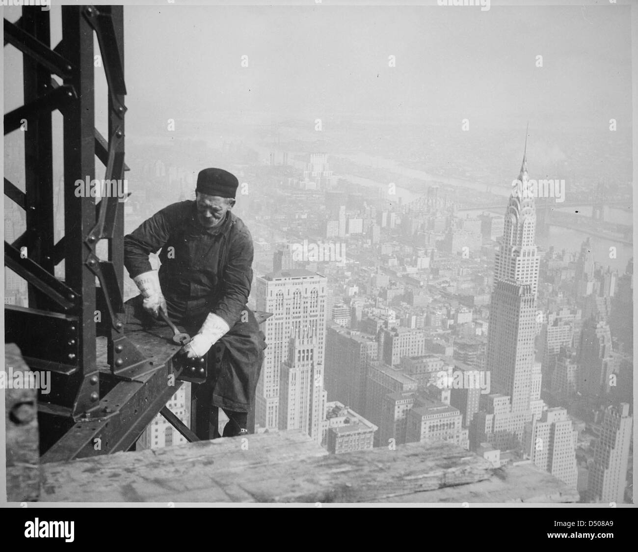 A 1936 photograph by Lewis Hine showing a worker on the framework of ...