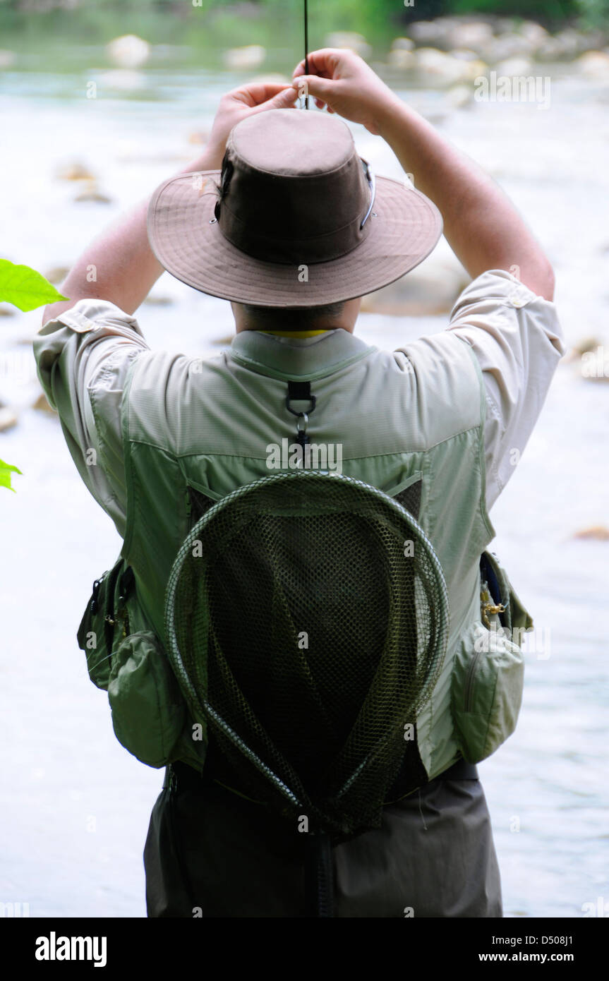 A man fly fishing in a river Stock Photo - Alamy