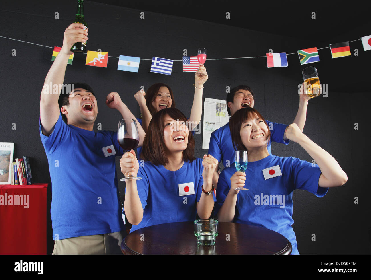 Young supporters cheering in a bar Stock Photo - Alamy