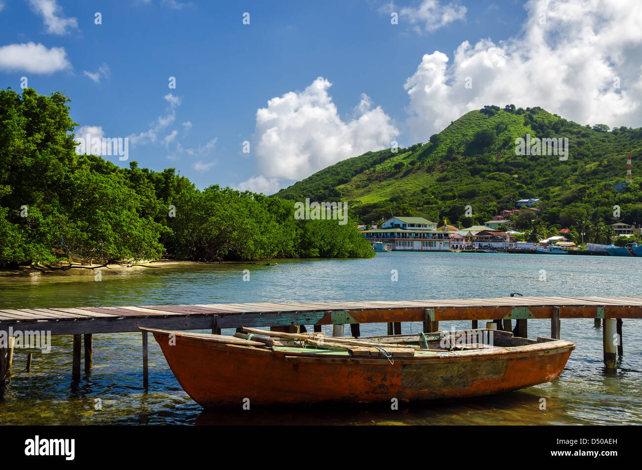 Old worn out boat and dock with tropical island in the background Stock ...