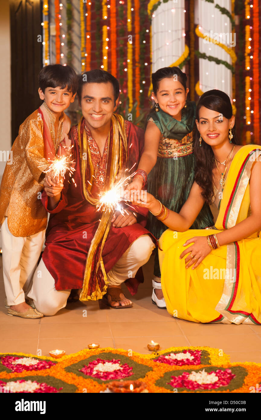 Family burning fire crackers on Diwali Stock Photo - Alamy
