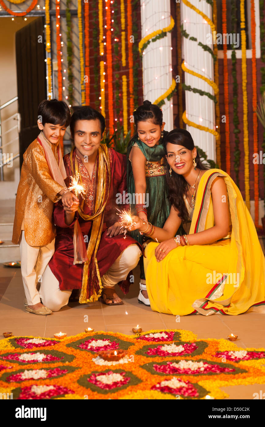 Family burning fire crackers on Diwali Stock Photo - Alamy