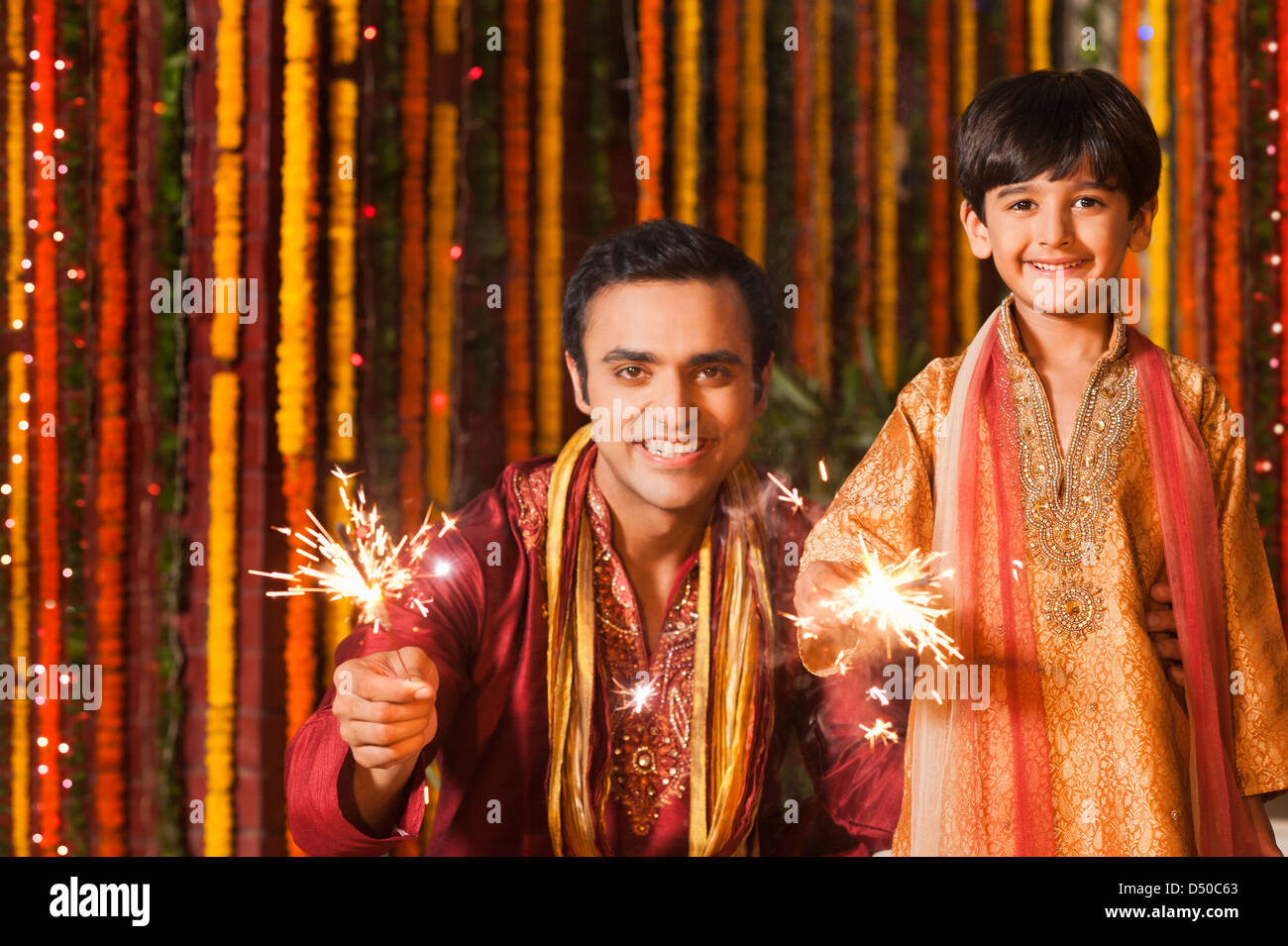 Man and his son burning fire crackers on Diwali Stock Photo - Alamy