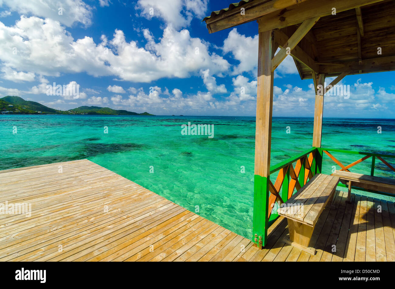 Wooden dock in Caribbean sea with beautiful turquoise and blue water in ...