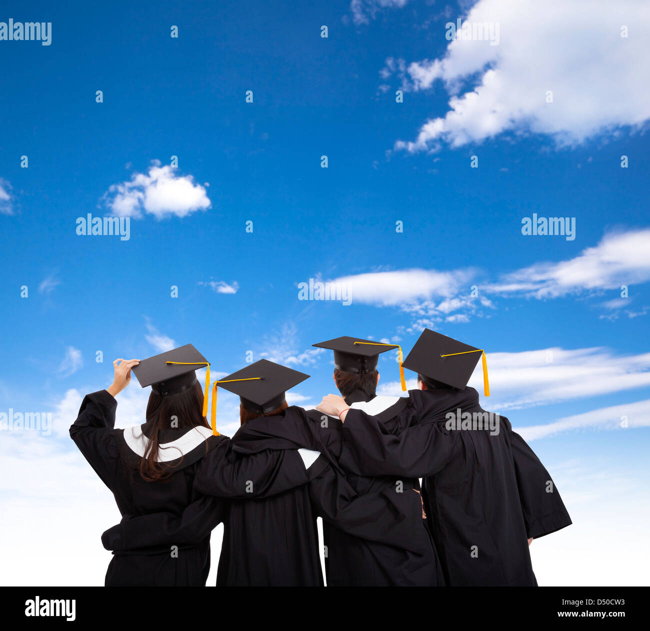 four graduate students looking at sky Stock Photo - Alamy