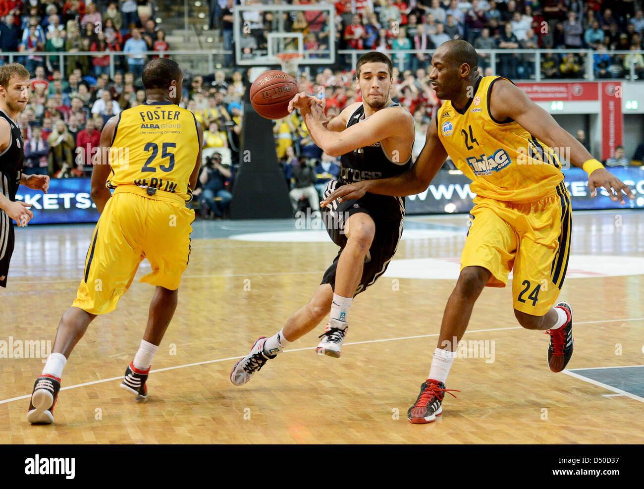 Bamberg's Daniel Schmidt veis for the ball with Berlin's Je'Kel Foster ...
