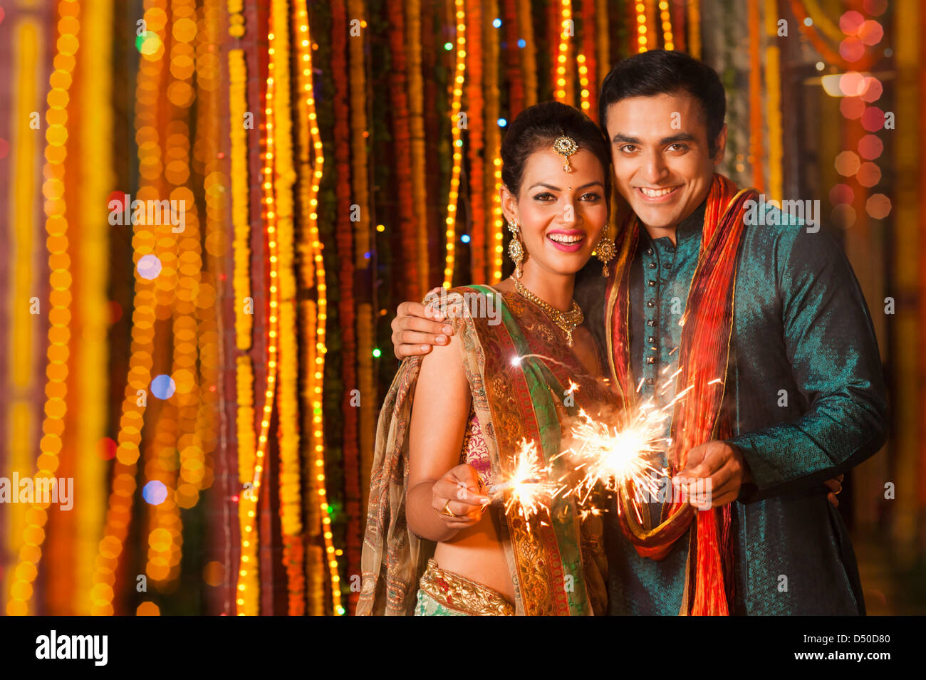Couple burning fire crackers on Diwali Stock Photo - Alamy