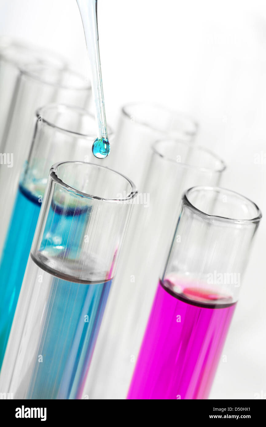 liquid dripping from pipette into test tube Stock Photo - Alamy