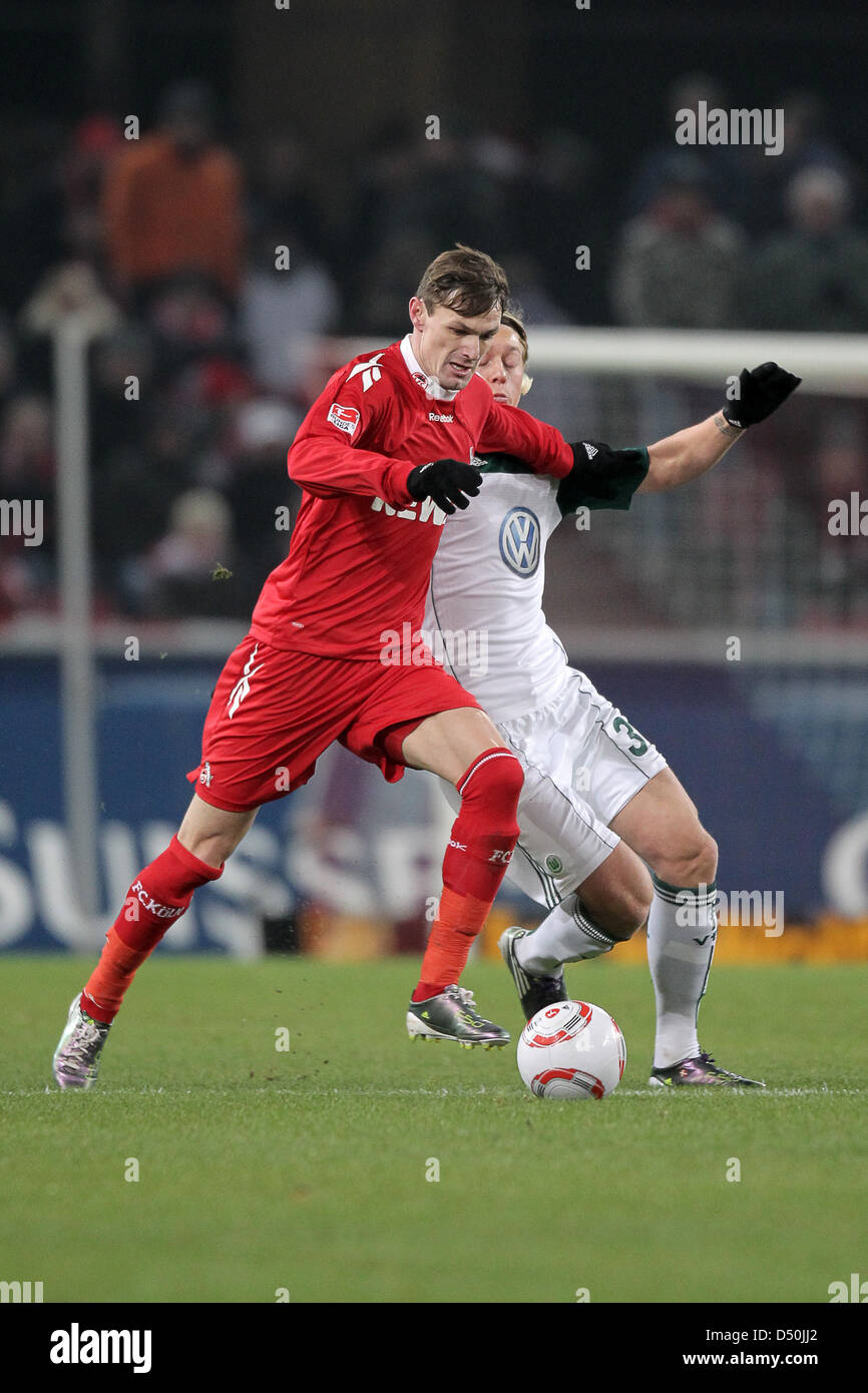 Cologne's Milivoje Novakovic (l) and Wolfsburg's Simon Kjaer (r) try to ...